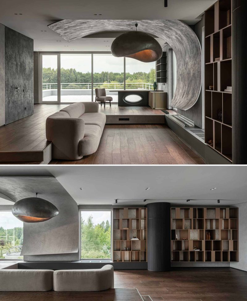 A Curved Accent Wall Wraps Around From The Fireplace To The Ceiling ...