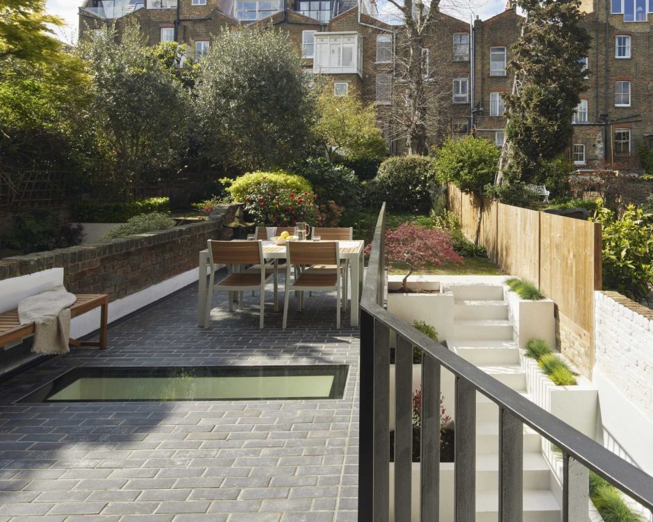 Stairs With Built-In Planters Lead To The Back Garden At This Home