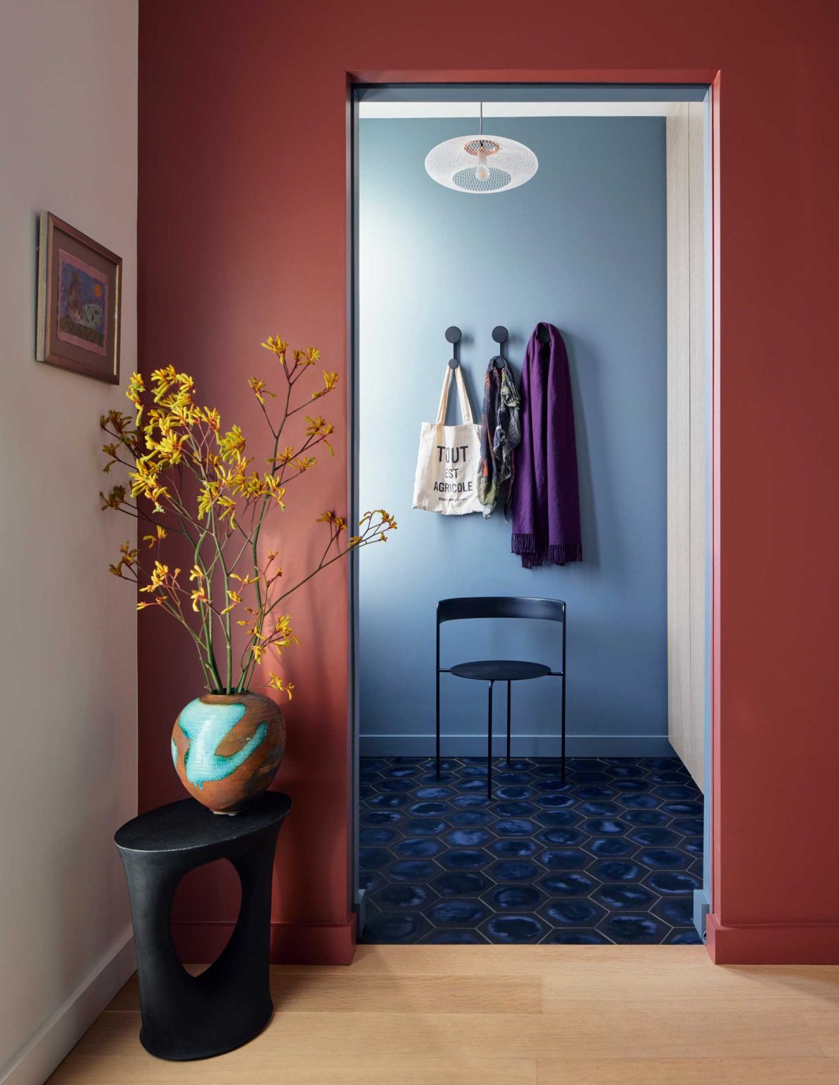 A Kitchen Wrapped In Textured Wood Defines The Boundary Of The Workspace