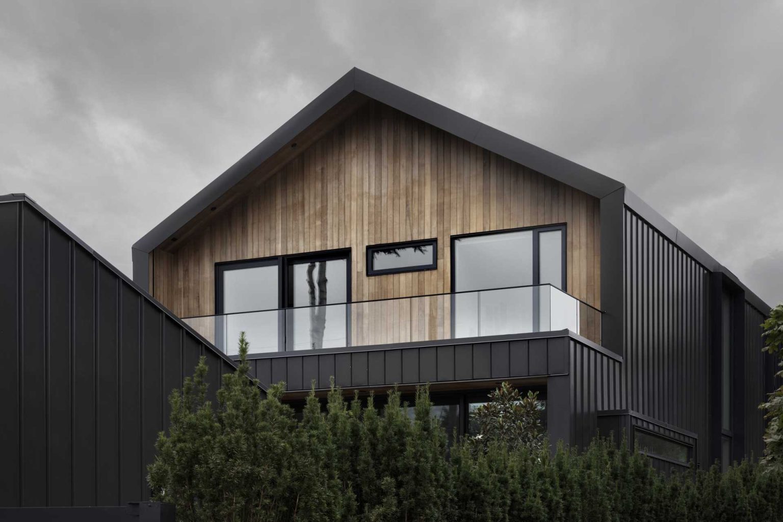 Metal Cladding Wraps Around The Large Gable Roof Of This House