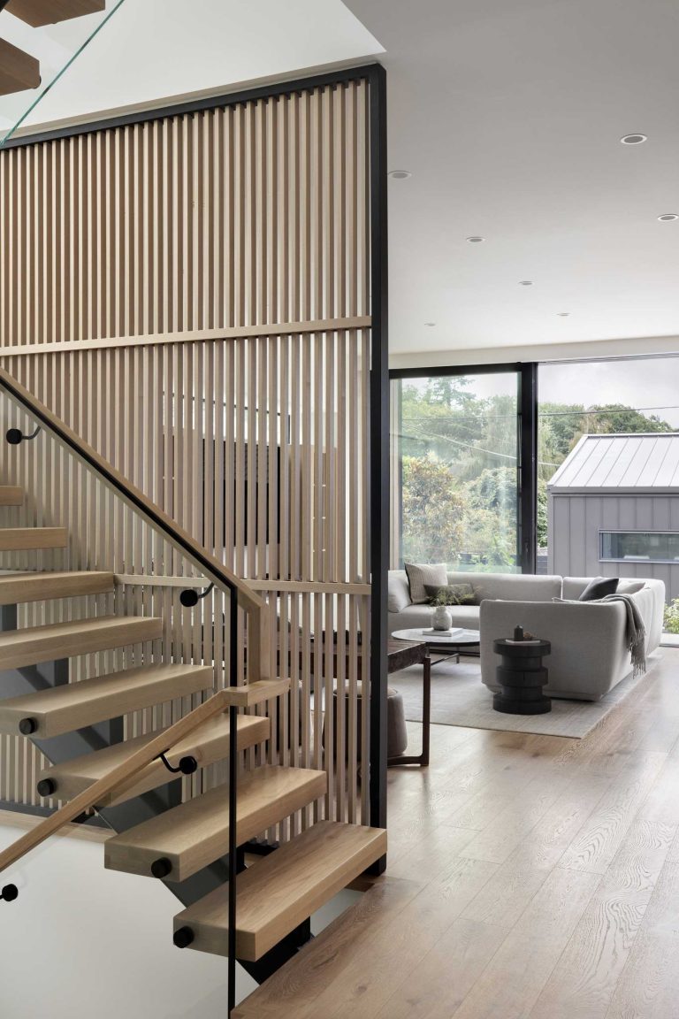 Metal Cladding Wraps Around The Large Gable Roof Of This House