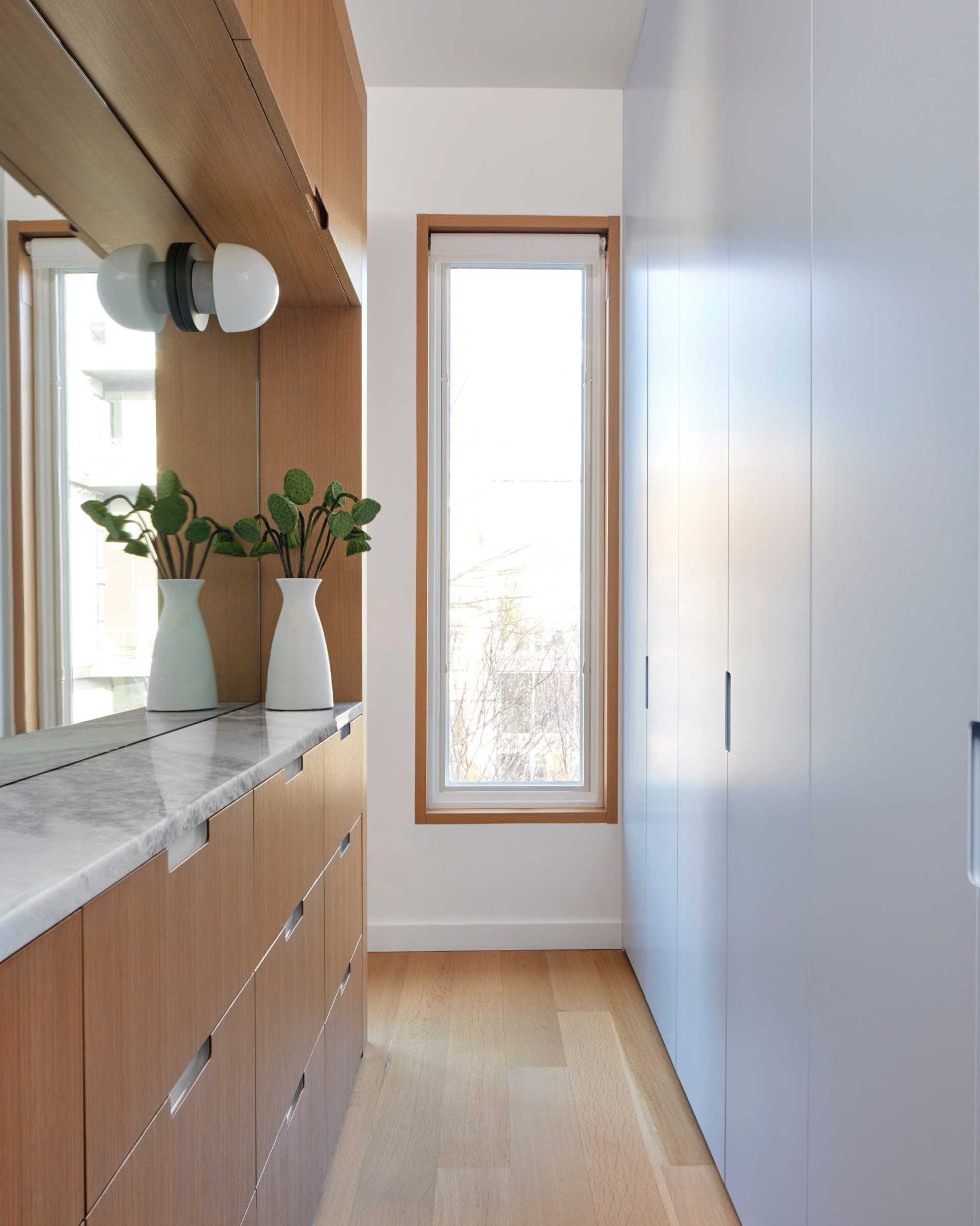 A Kitchen Wrapped In Textured Wood Defines The Boundary Of The Workspace