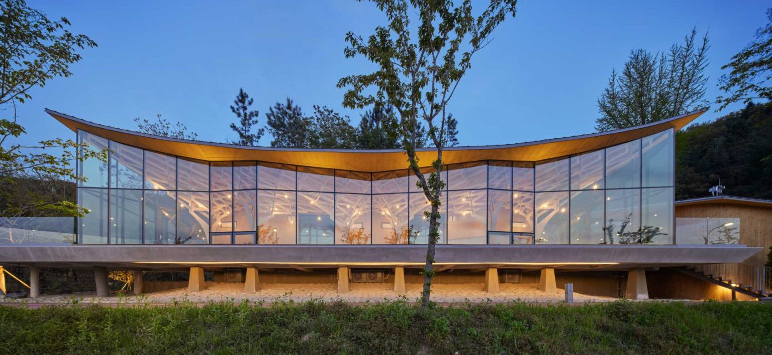 Tree-like Columns Show The Craftsmanship Inside This Riverside Pavilion