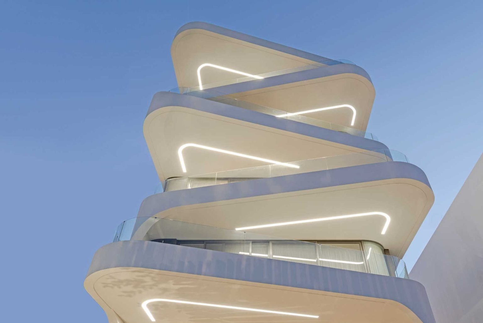 Lighting Highlights The Alternating Curvilinear Balconies Of This New ...