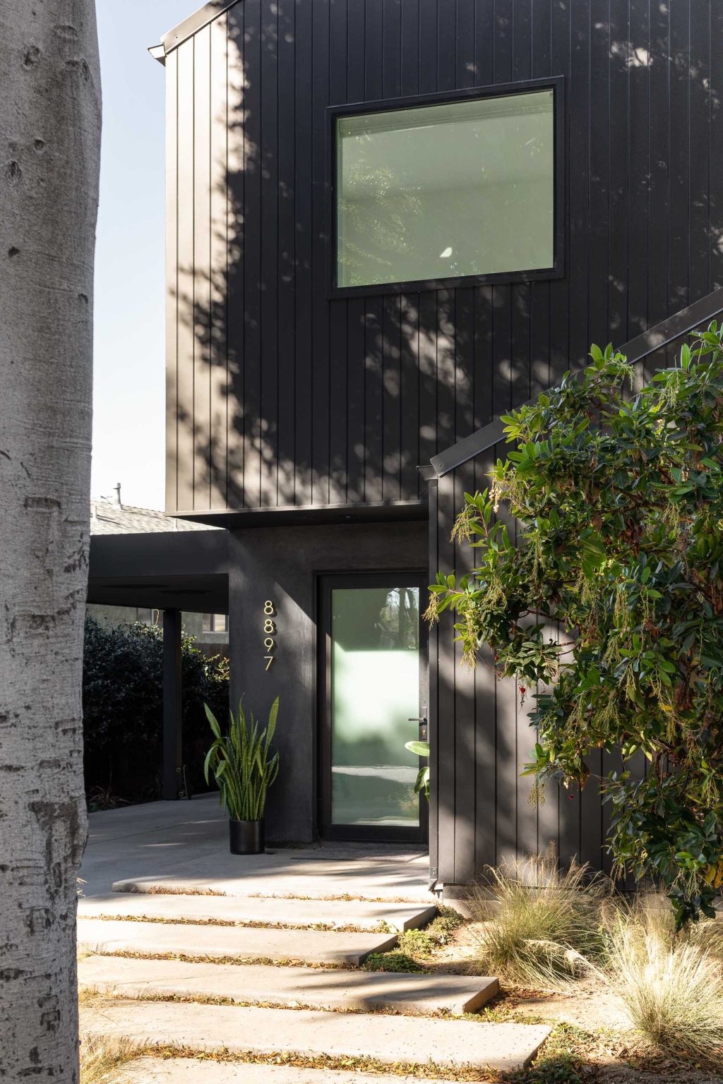 The Black Exterior Of This Barn-Inspired Home Is Contrasted With A ...