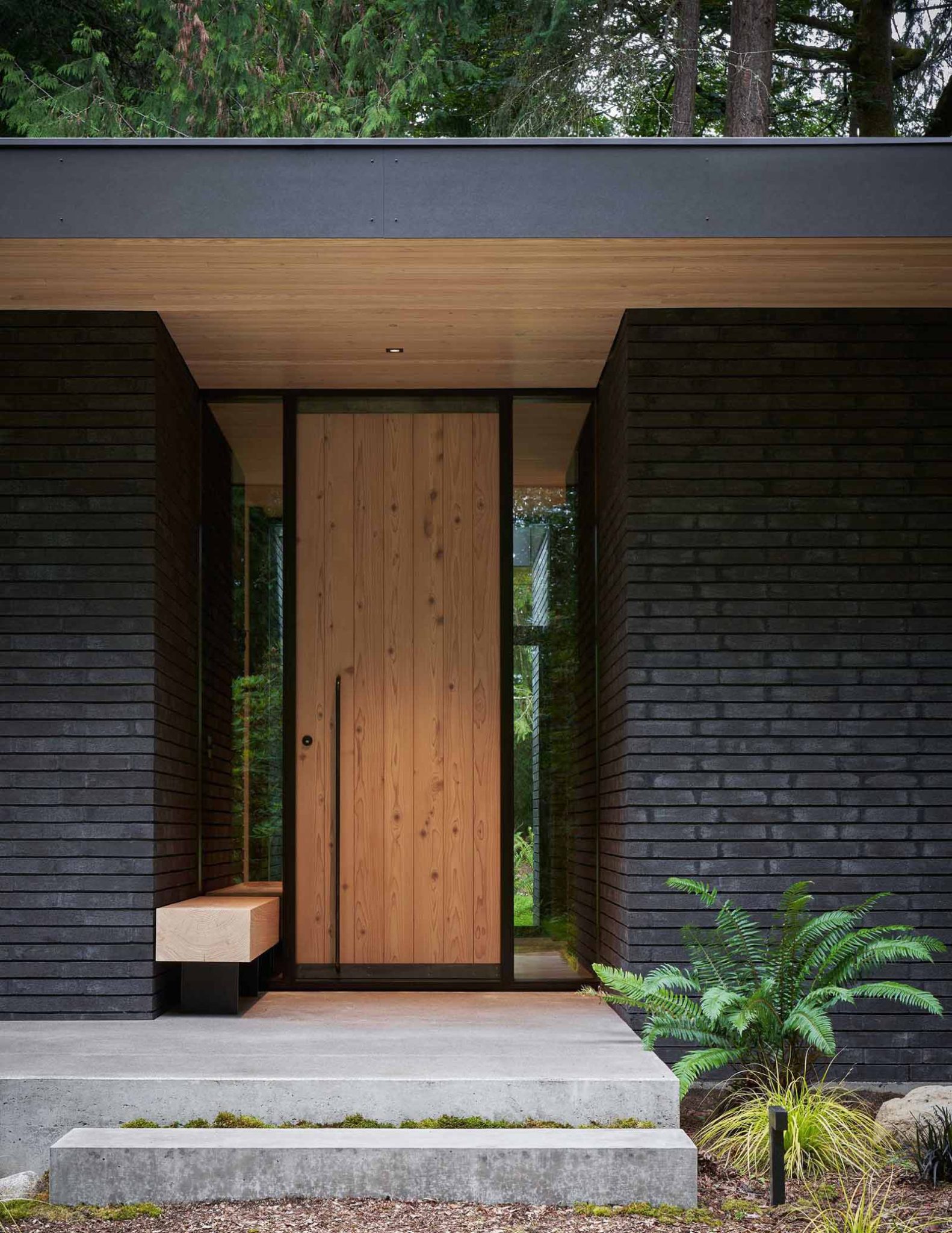 A Black Brick Exterior Is Consistent With The Dark Forest Surrounding ...