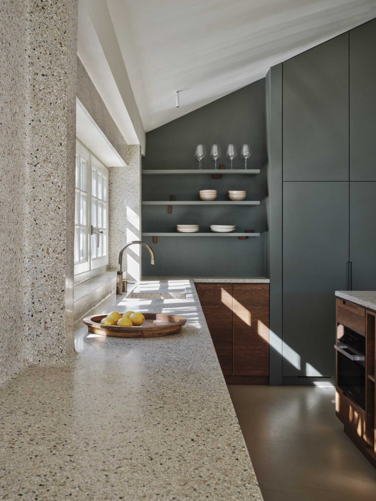 A Seamless Terrazzo Flows From The Wall To The Countertop In This Kitchen