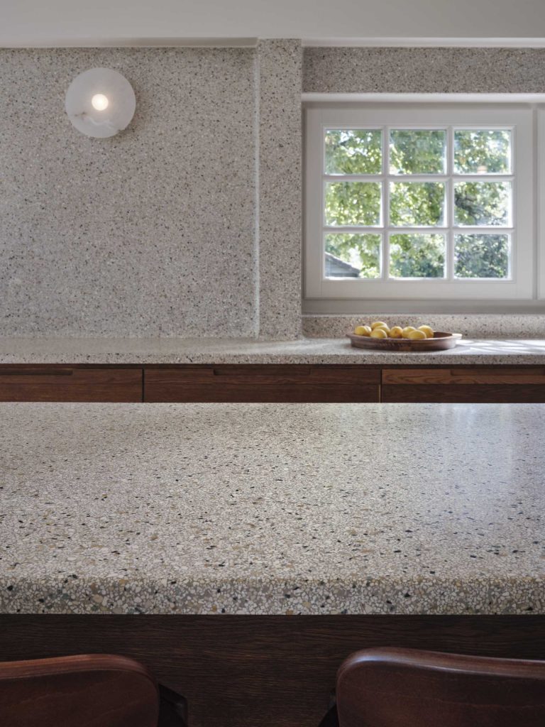 A Seamless Terrazzo Flows From The Wall To The Countertop In This Kitchen