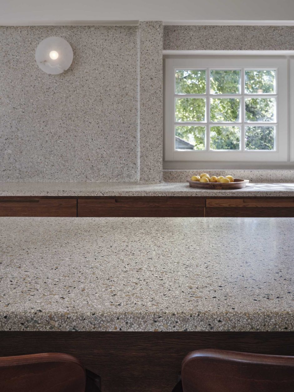 A Seamless Terrazzo Flows From The Wall To The Countertop In This Kitchen