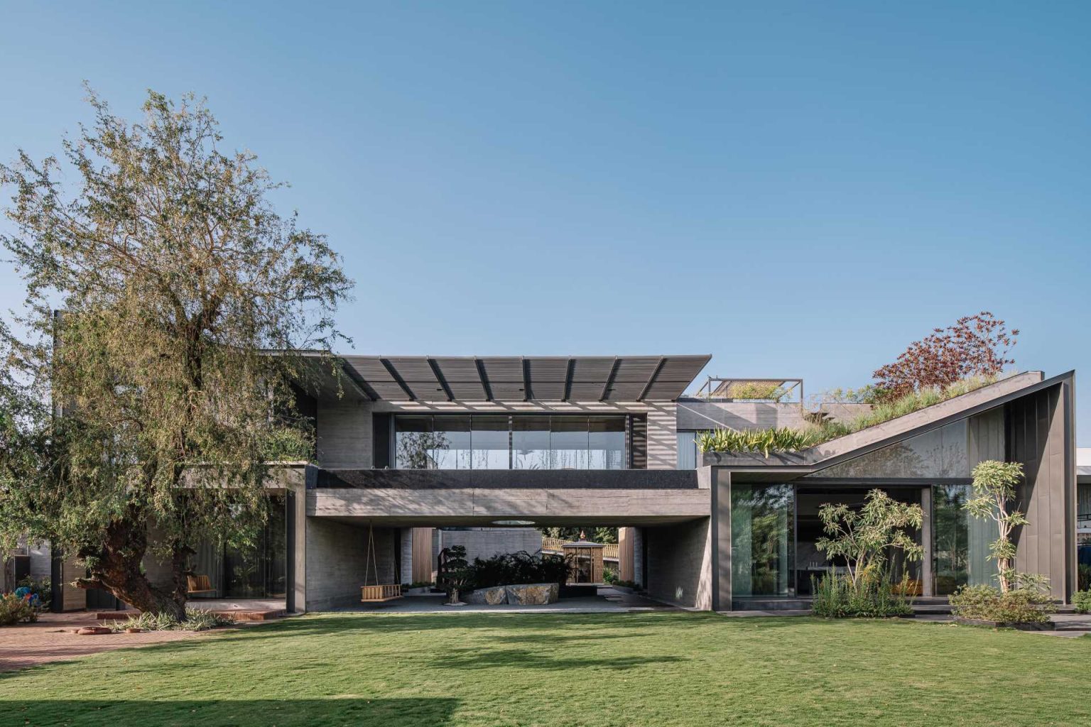 A Curving Bridge Leads To The Entertainment Areas Of This Modern Home