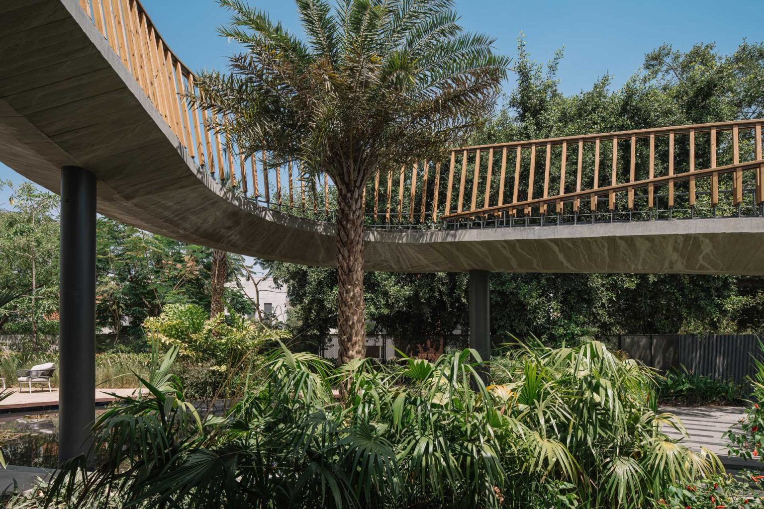 A Curving Bridge Leads To The Entertainment Areas Of This Modern Home