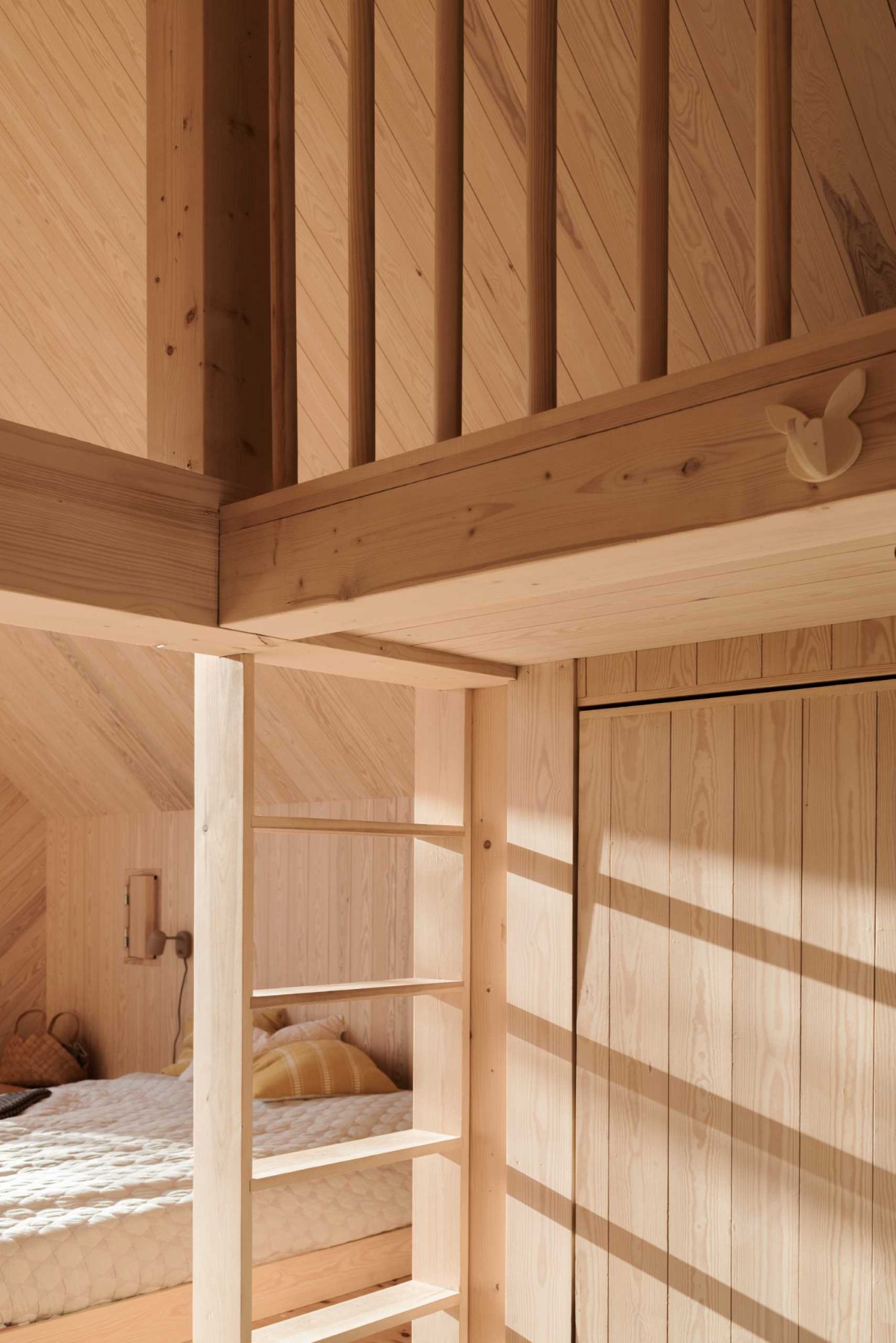 A Unique Window Shape Helps Frame The View From Inside This Cabin