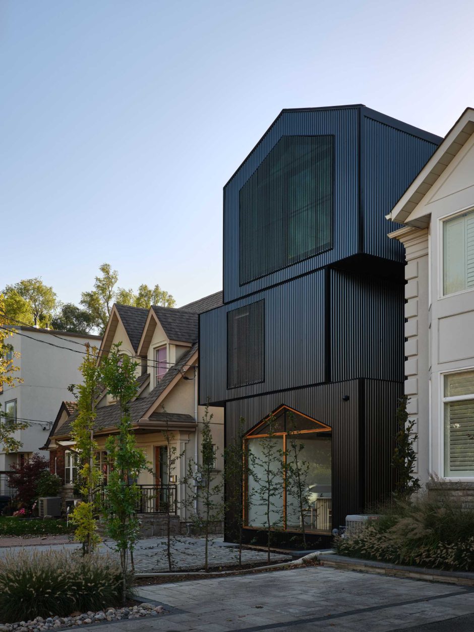 This Tall Black House Appears To Be Made From A Series Of Stacked Boxes