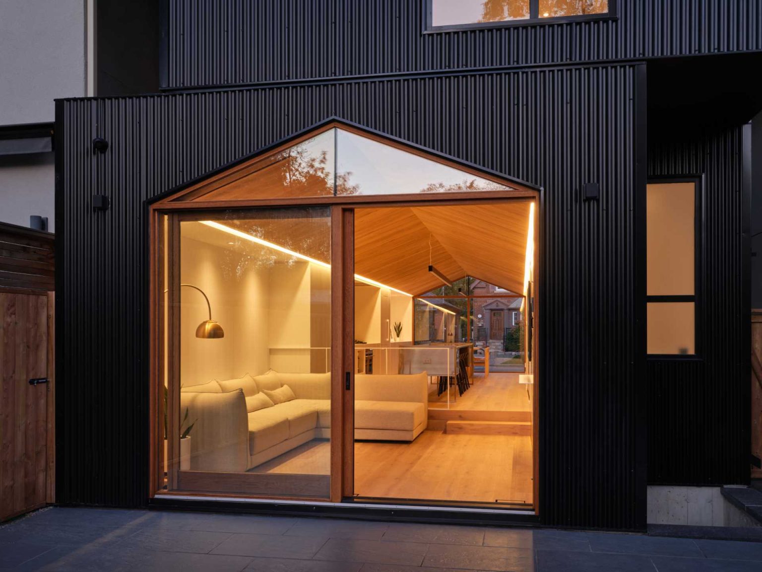 This Tall Black House Appears To Be Made From A Series Of Stacked Boxes