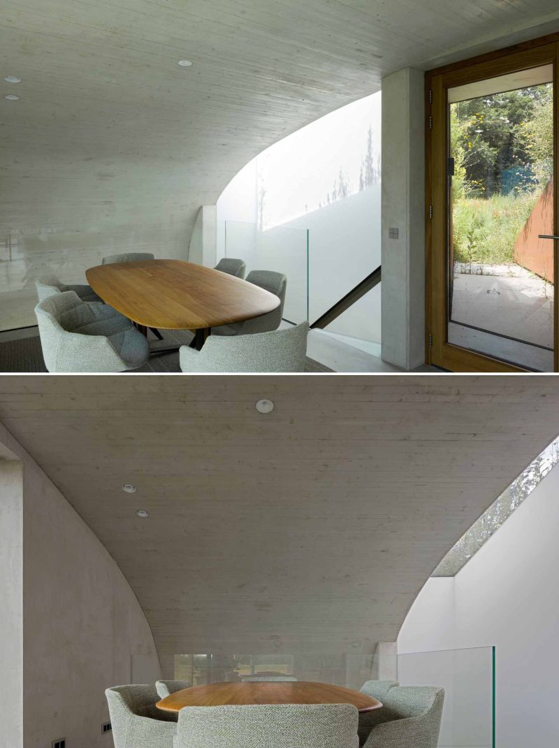 A House Built Into The Ground And Covered In Flowers