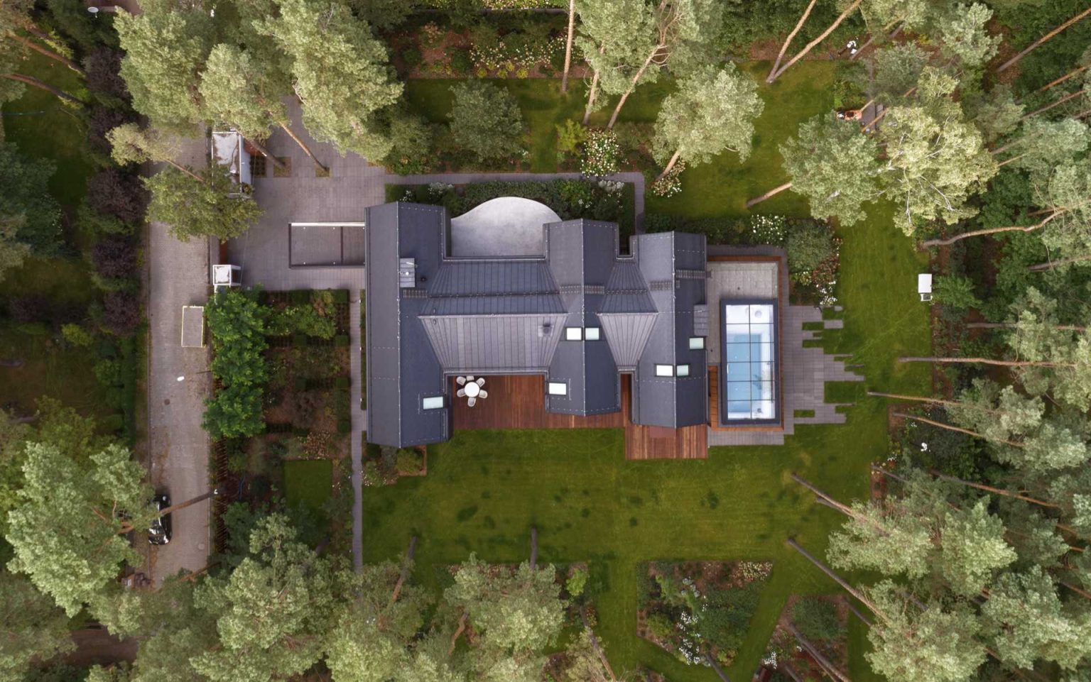 Elevated Elegance: A Unique Home In The Forest With A Trio Of Tile-Clad Gables