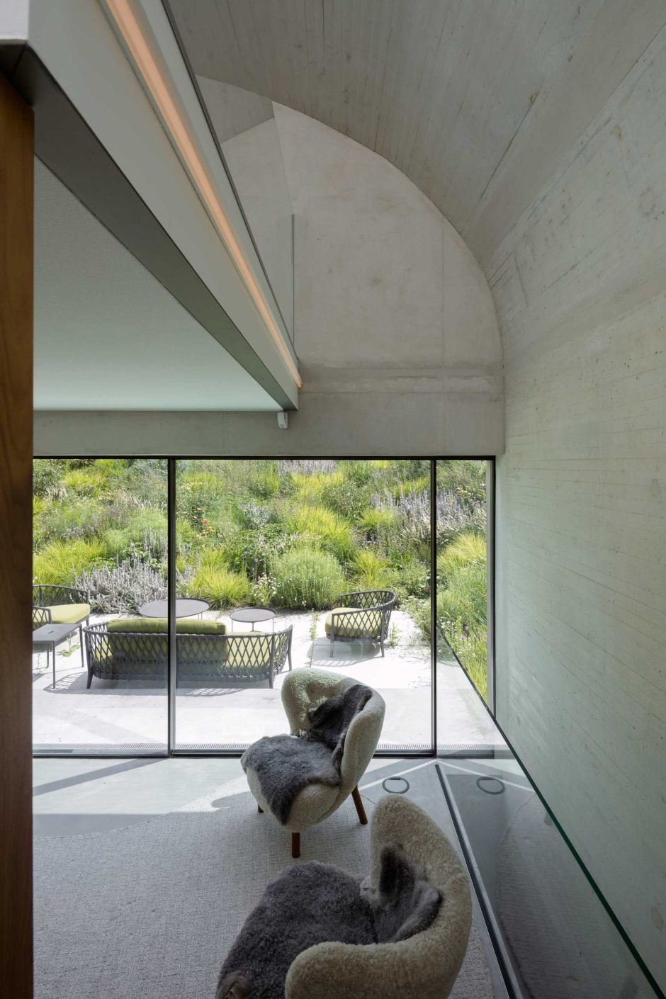 A House Built Into The Ground And Covered In Flowers