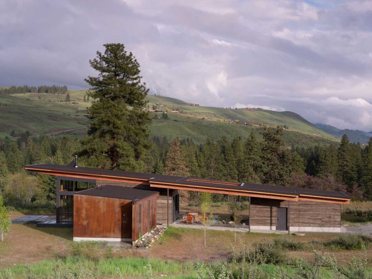 A Dramatic Upward-Sloping Roof Covers This Rural Home