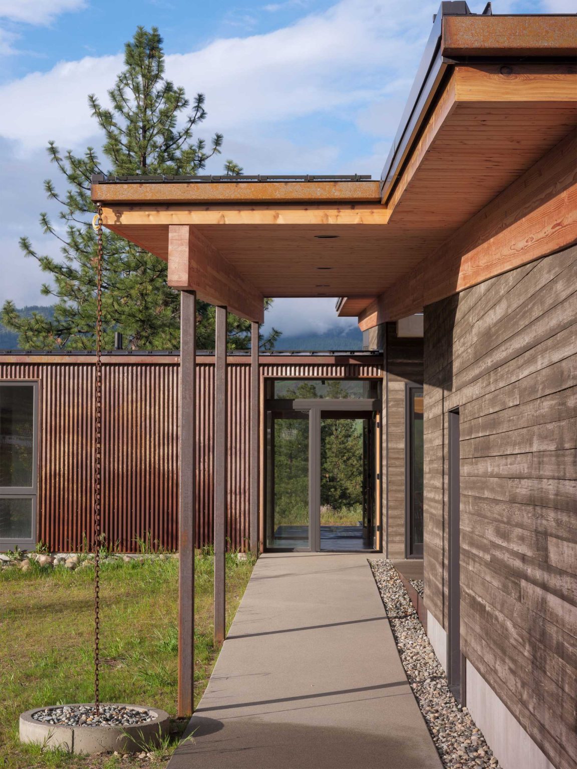 A Dramatic Upward-Sloping Roof Covers This Rural Home
