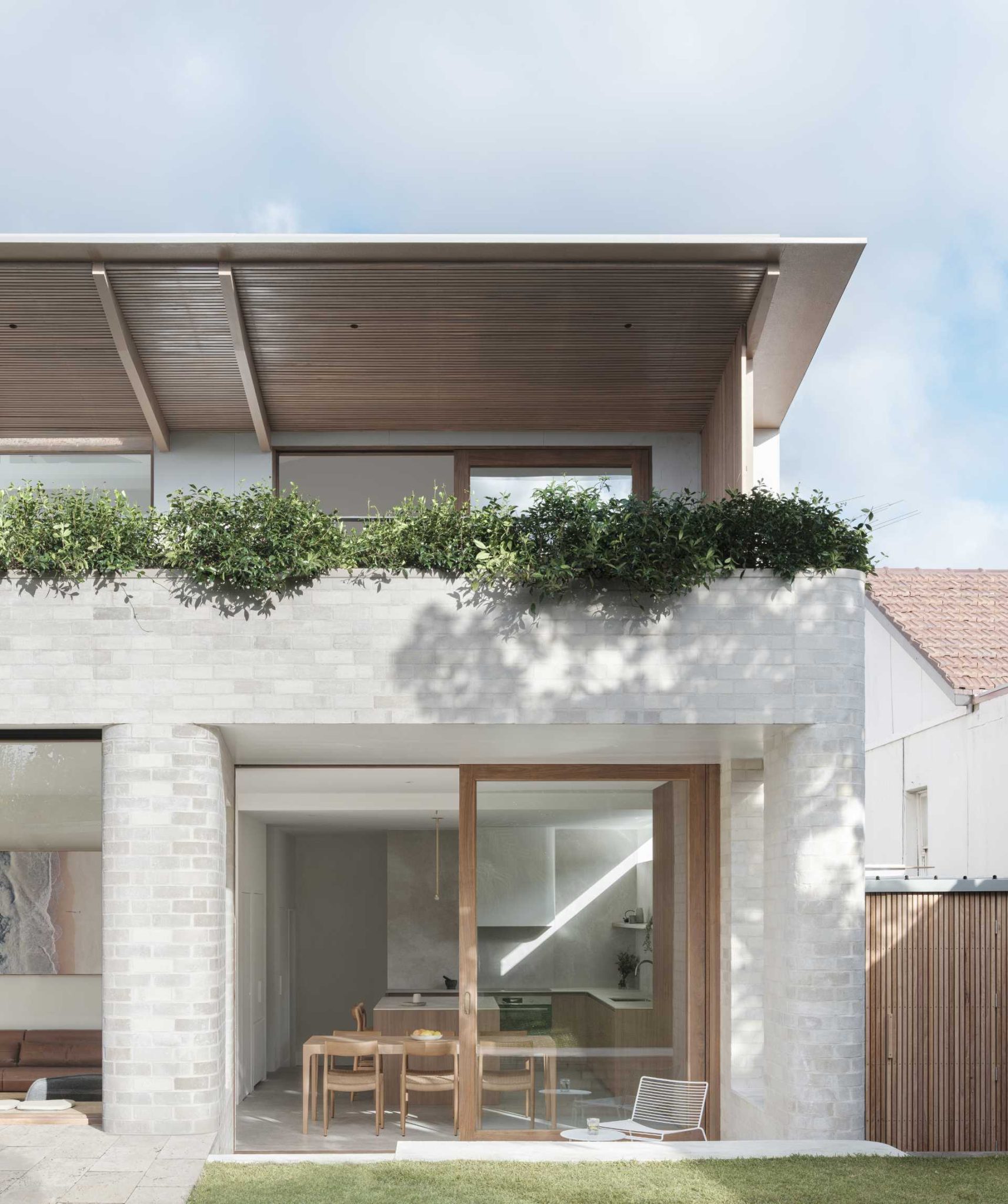 A Material Palette Of Pale Brick, Concrete, And Timber Echoes This Home ...