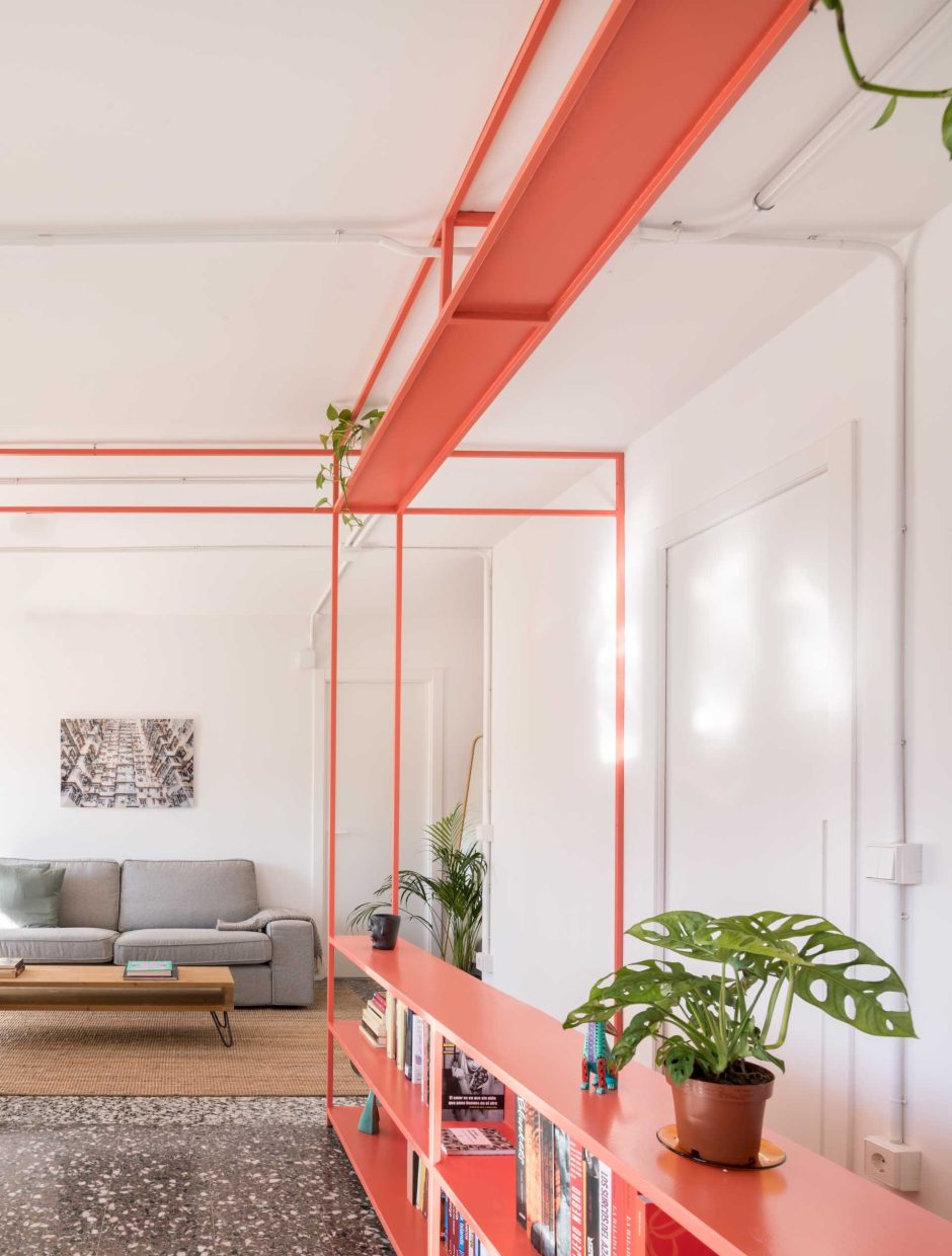 A Brightly Coloured Shelving Unit Helps To Define Areas In This ...