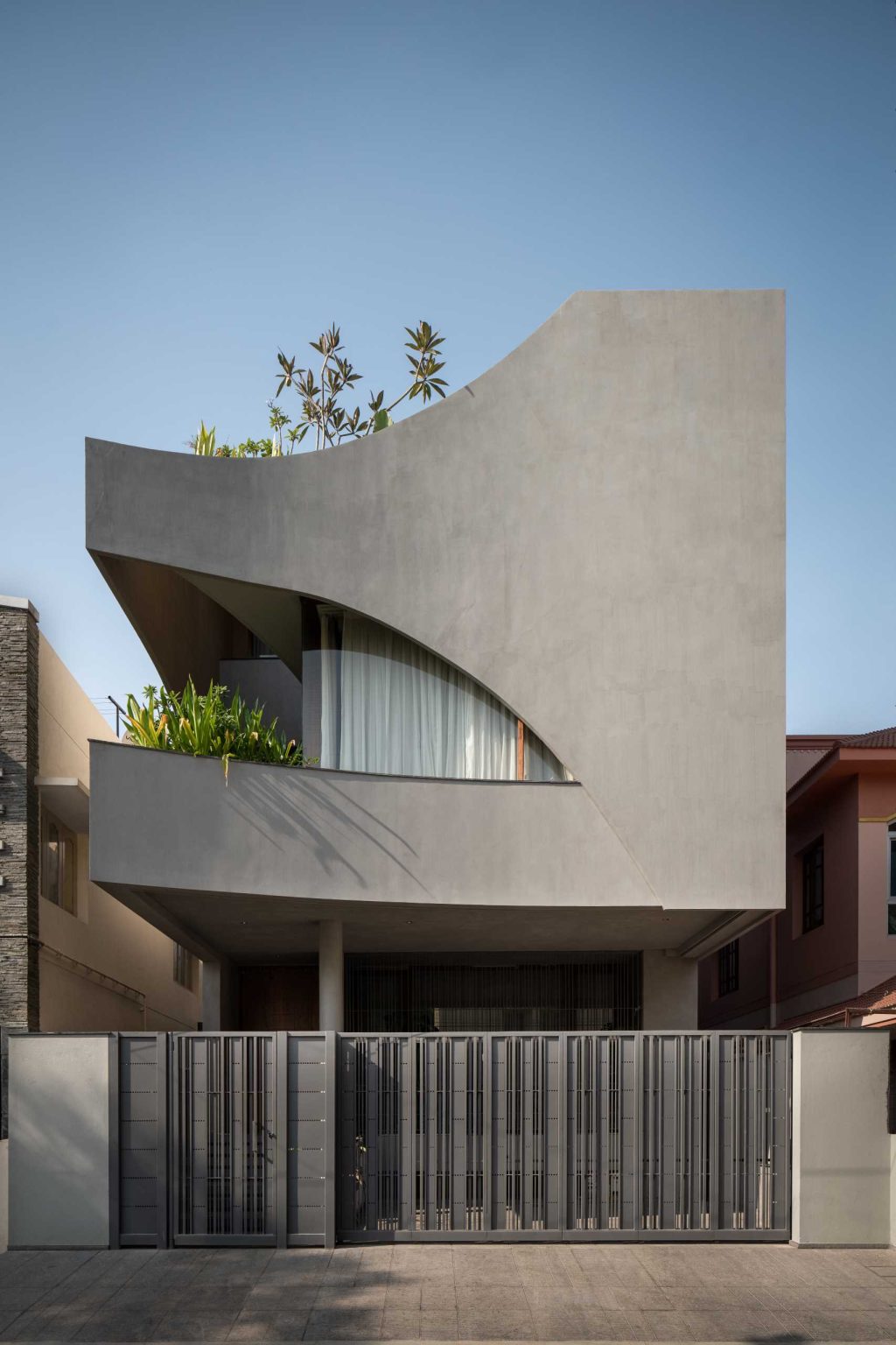 A Curvy Concrete Cube With Cut Outs For Windows Is The Form Of This New ...