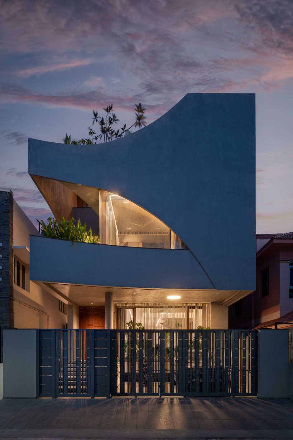 A Curvy Concrete Cube With Cut Outs For Windows Is The Form Of This New Home