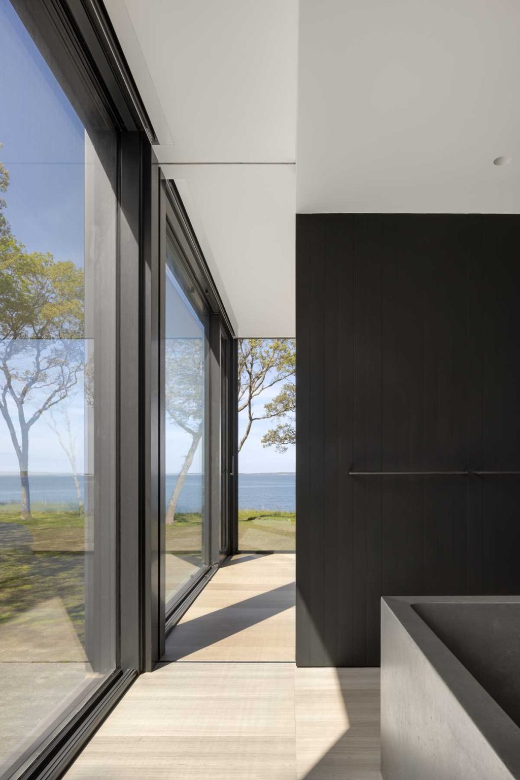 A Grid Of Large Windows Maximizes The Water Views At This Modern Home