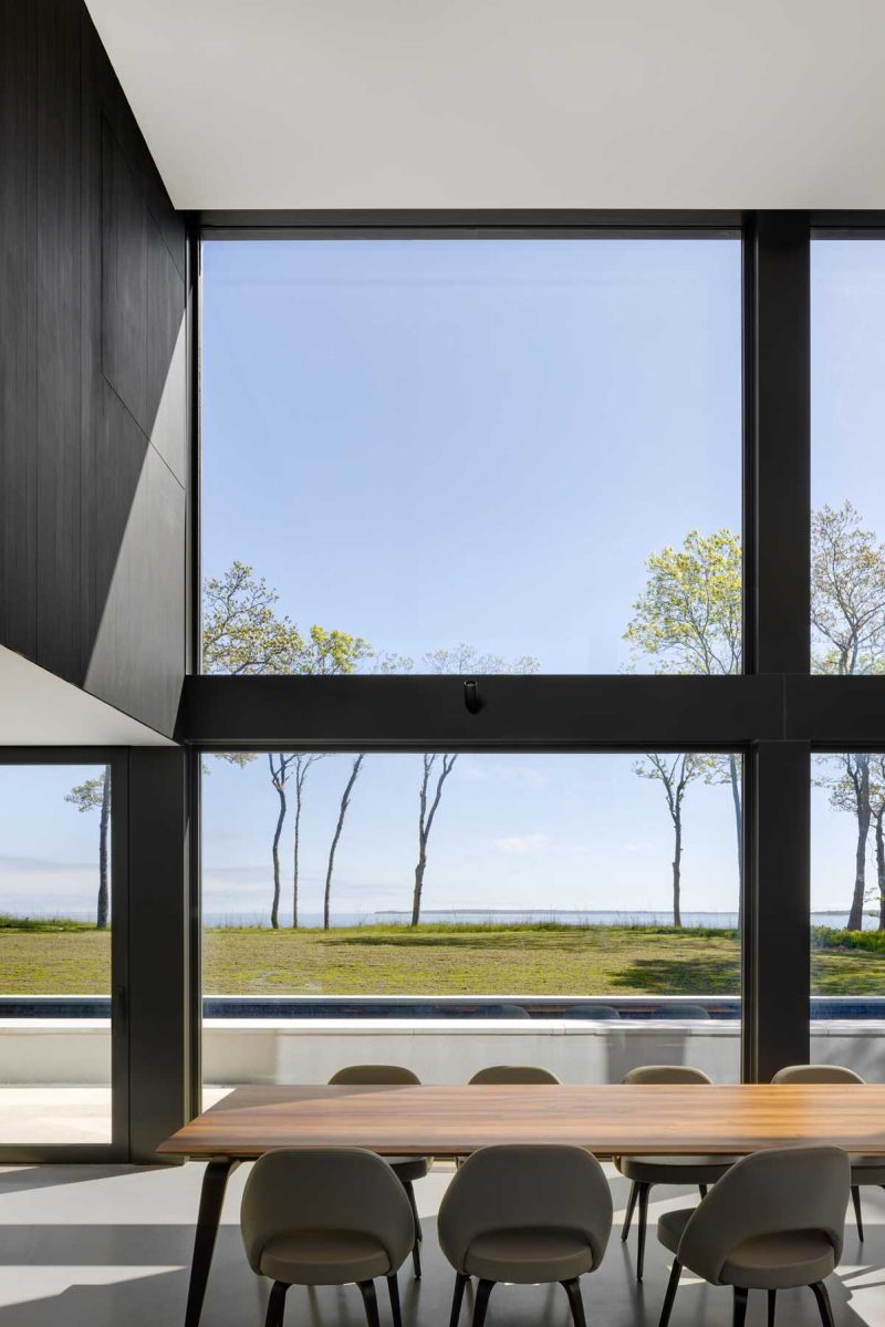A Grid Of Large Windows Maximizes The Water Views At This Modern Home