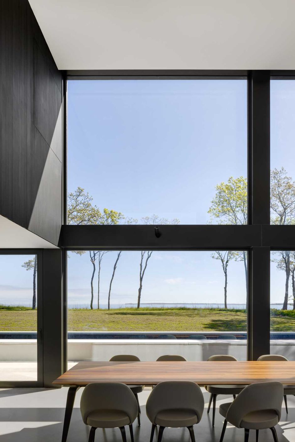 A Grid Of Large Windows Maximizes The Water Views At This Modern Home