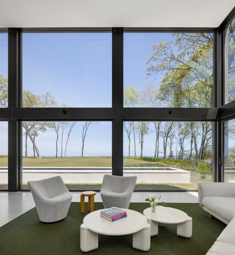 A Grid Of Large Windows Maximizes The Water Views At This Modern Home