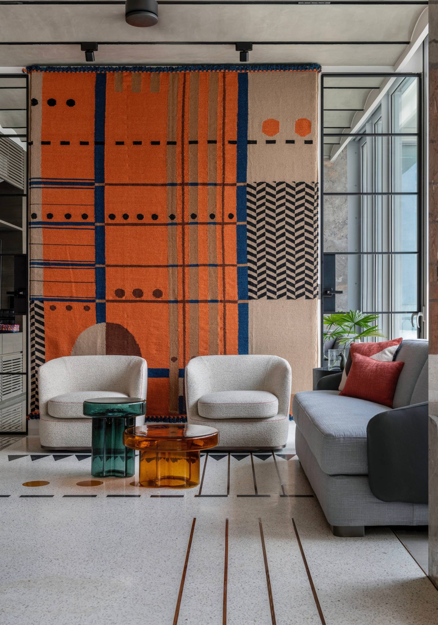 An Orange Spiral Staircase Is An Eye-Catching Feature Inside This Apartment
