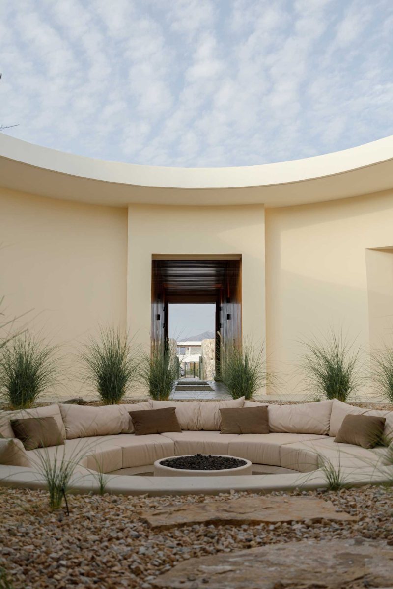 A Stone Covered Home That Surrounds A Central Courtyard With Sunken Seating