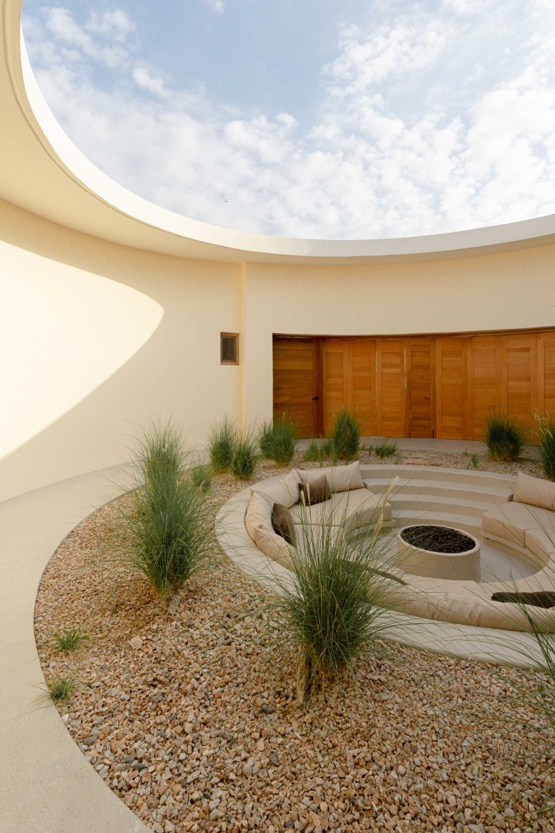A Stone Covered Home That Surrounds A Central Courtyard With Sunken Seating