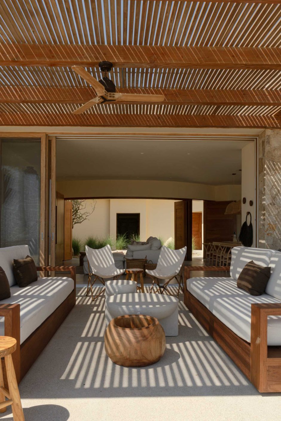 A Stone Covered Home That Surrounds A Central Courtyard With Sunken Seating
