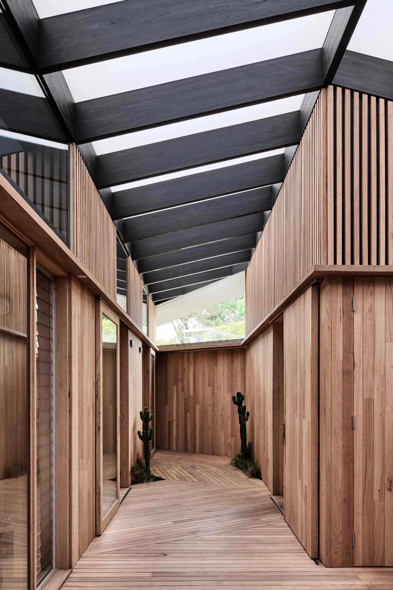 A beachside boardwalk reimagined as the spine of a modern home