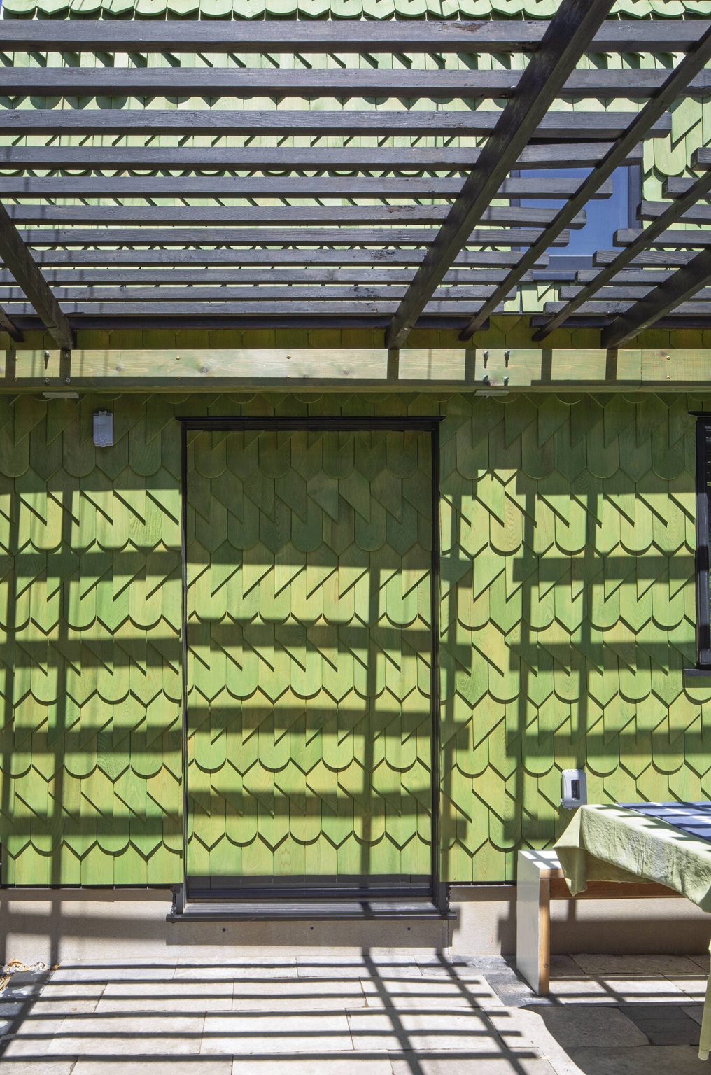 Dragon-Inspired Wood Shingles Cover This Laneway Garage