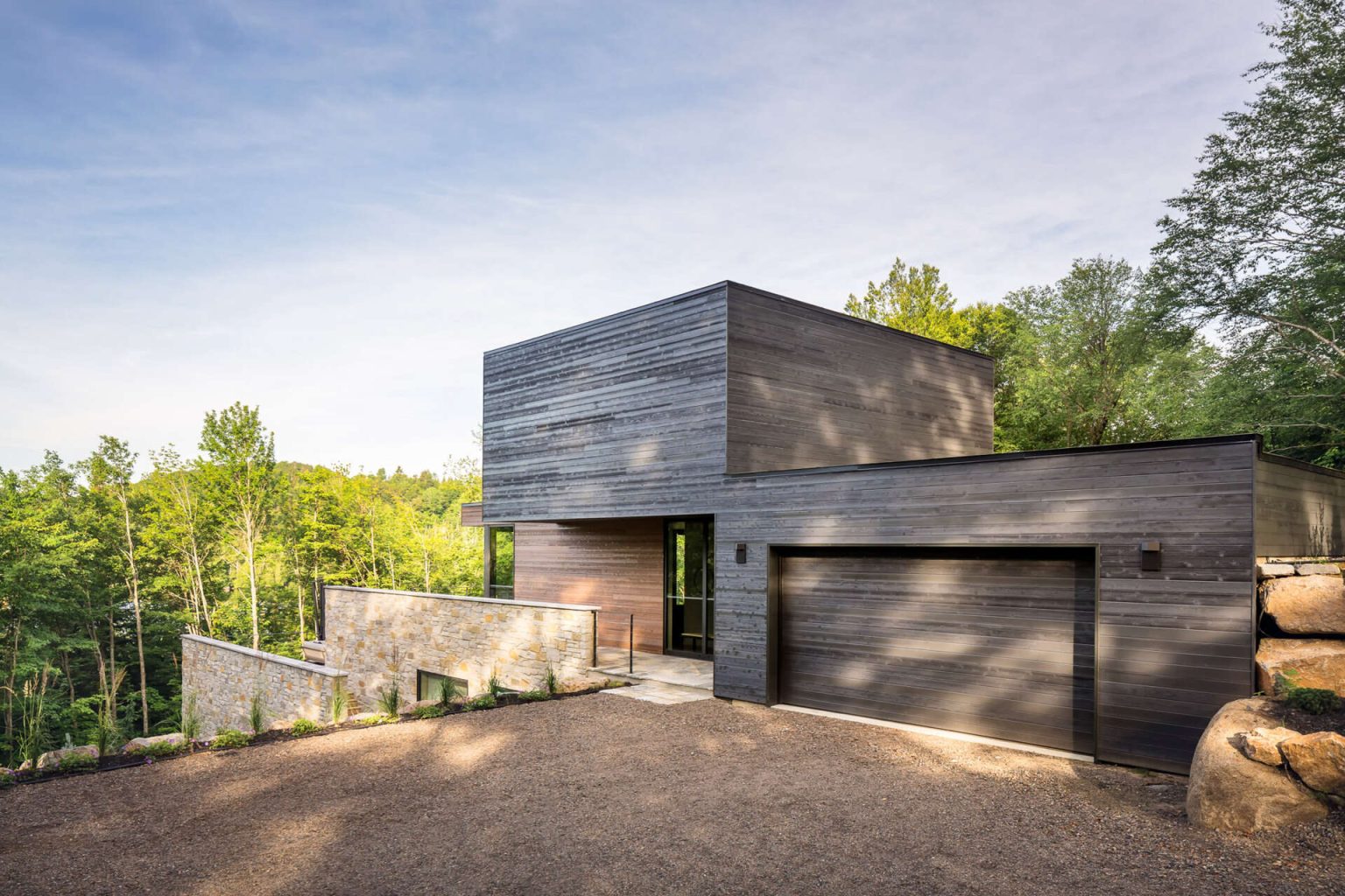 This Terraced House Reuses Excavated Stone for the Landscape