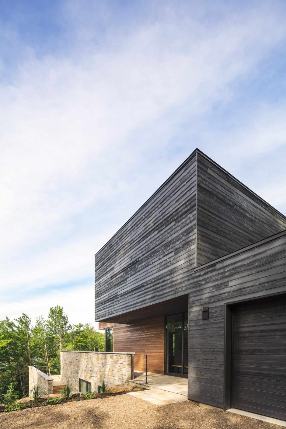 This Terraced House Reuses Excavated Stone for the Landscape