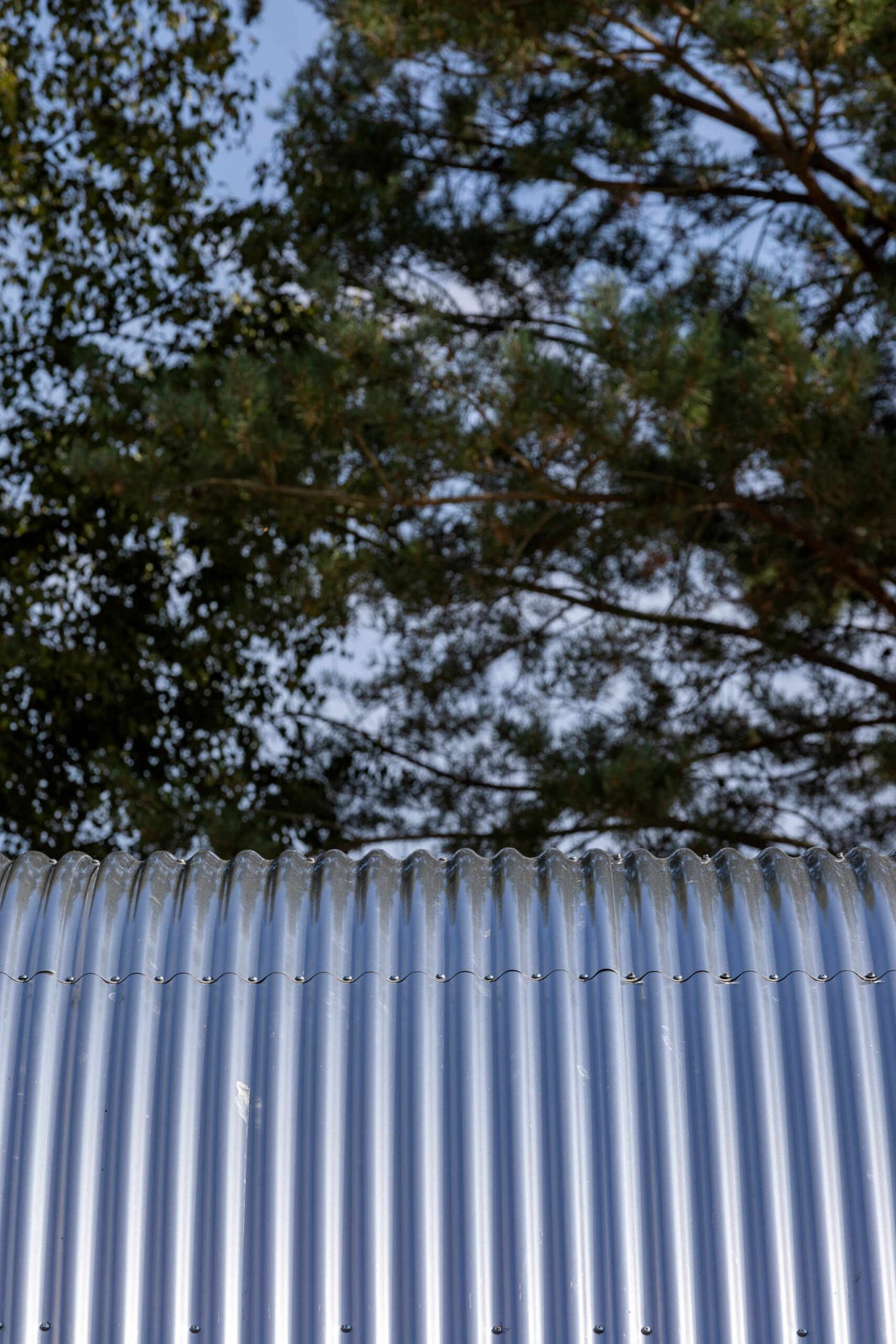 A Tube-Shaped Danish Summer Home With a Curved Corrugated Roof