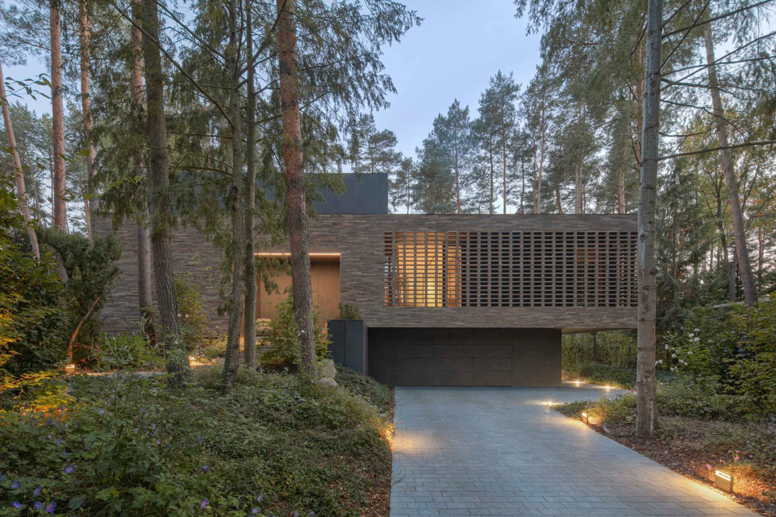 Curved Glass and Brick Define This Forest House